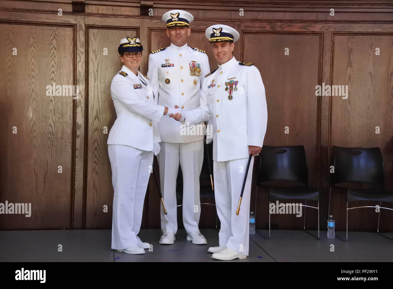 Cmdr. Erin E. Williams shakes hands with Cmdr. Alan H. Moore Jr. while ...