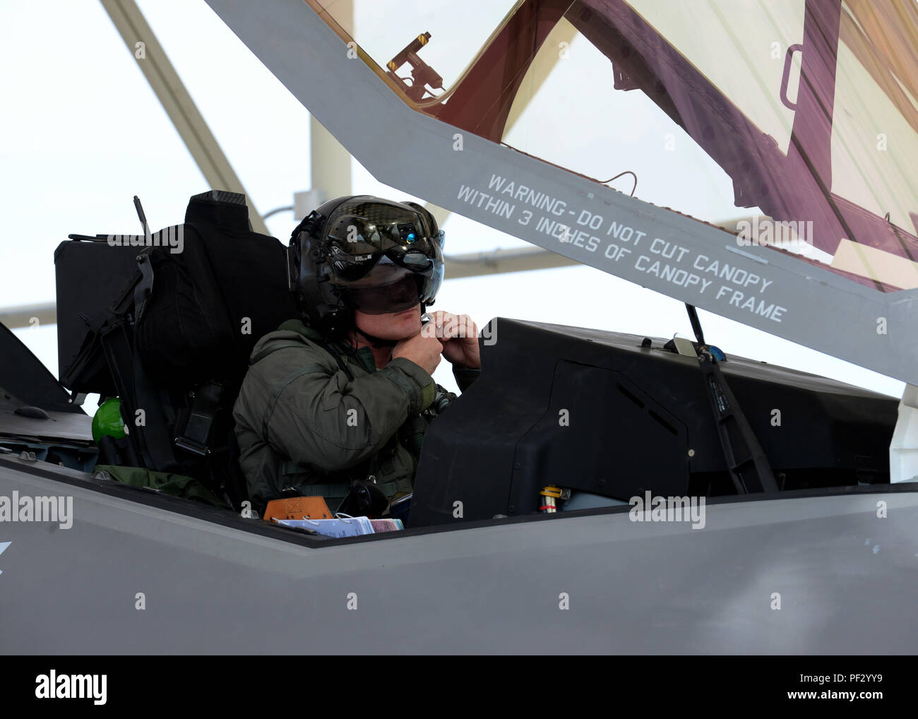 A U.S. Air Force F-35 Lightning II pilot fastens his helmet prior to ...