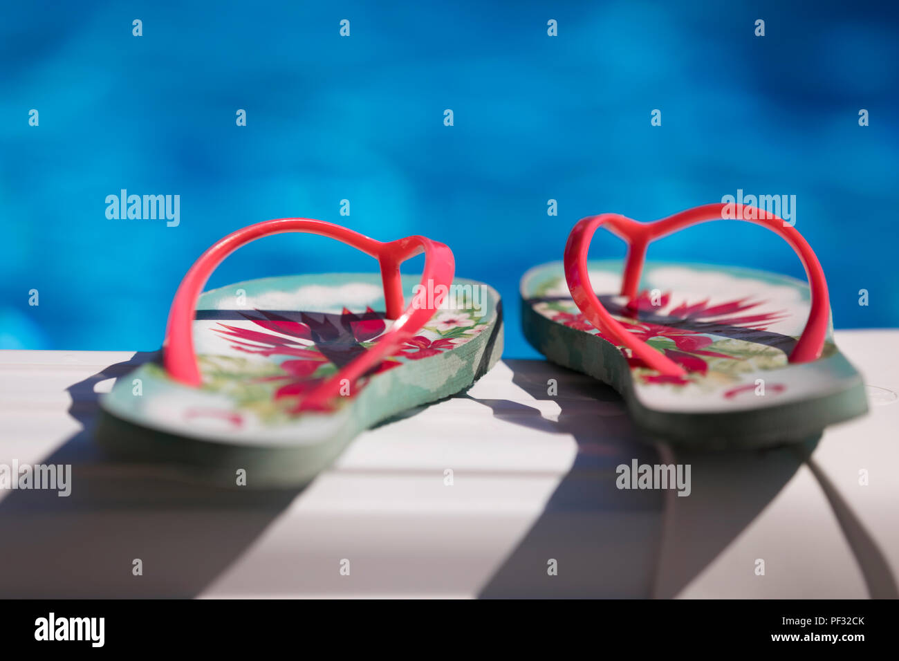 Flip flops on the edge of the swimming pool Stock Photo - Alamy