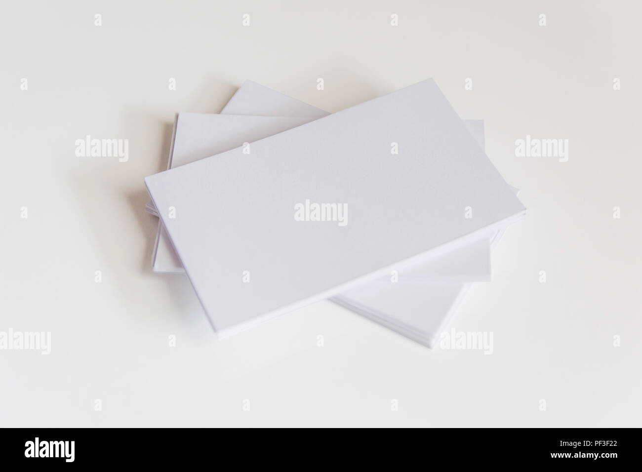 Stack of blank white business cards. Mockup business cards on white ...