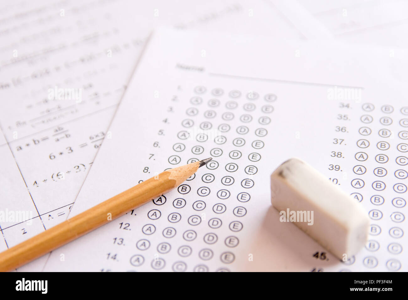 Pencil and eraser on answer sheets or Standardized test form with ...