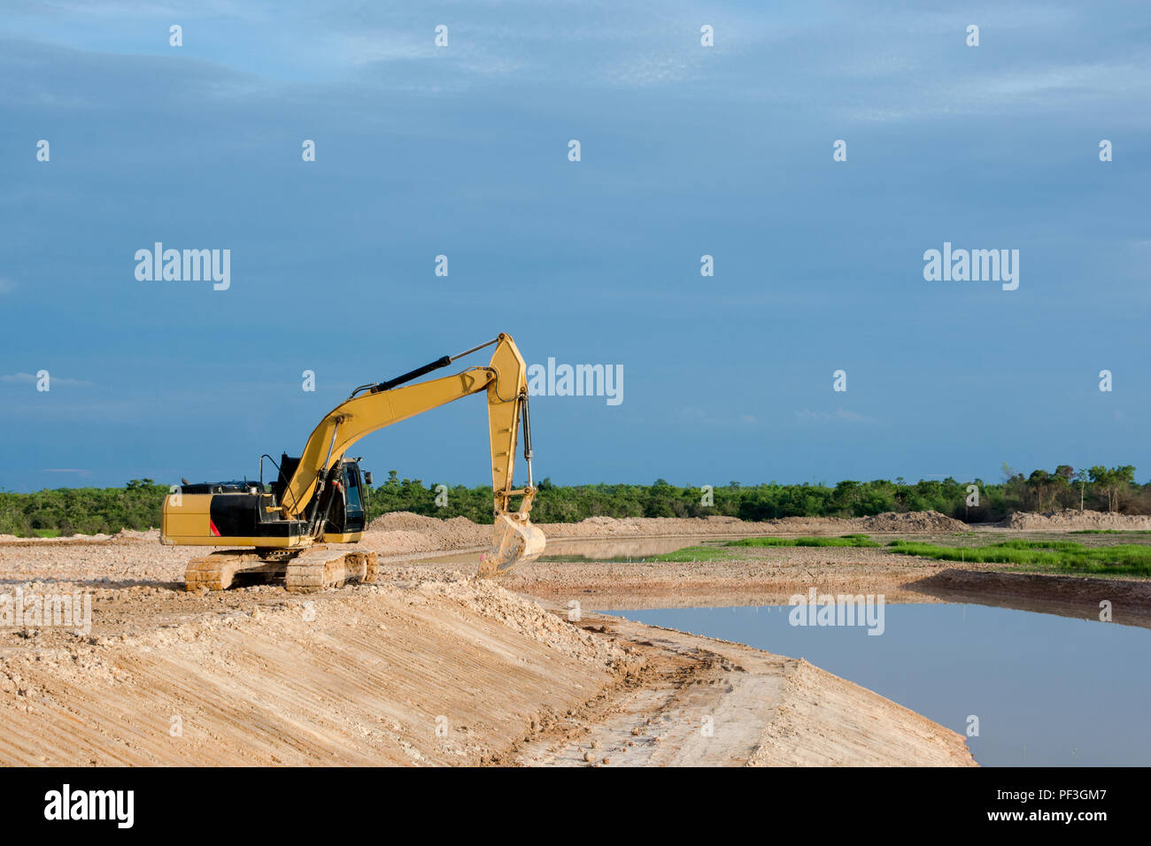 Yellow excavator machine working earth moving works riverside at ...