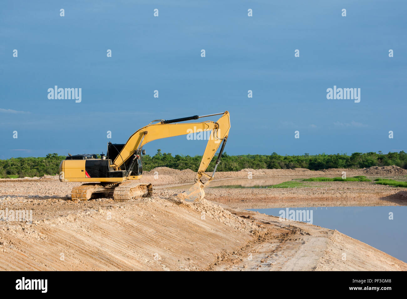 Yellow excavator machine working earth moving works riverside at ...