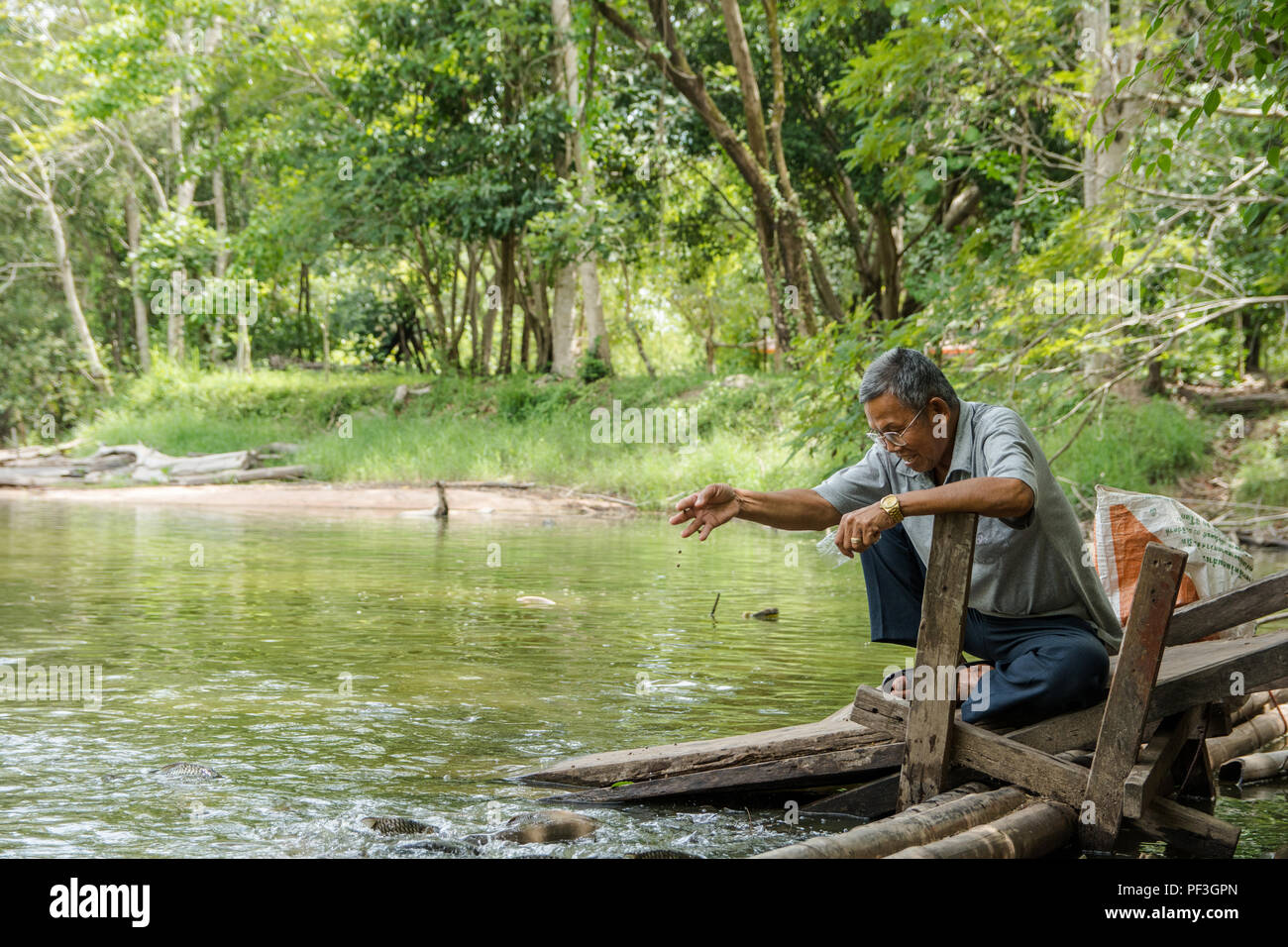 NAKHONPHANOM, THAILAND - MAY 12, 2018 : old man people feeding food to ...
