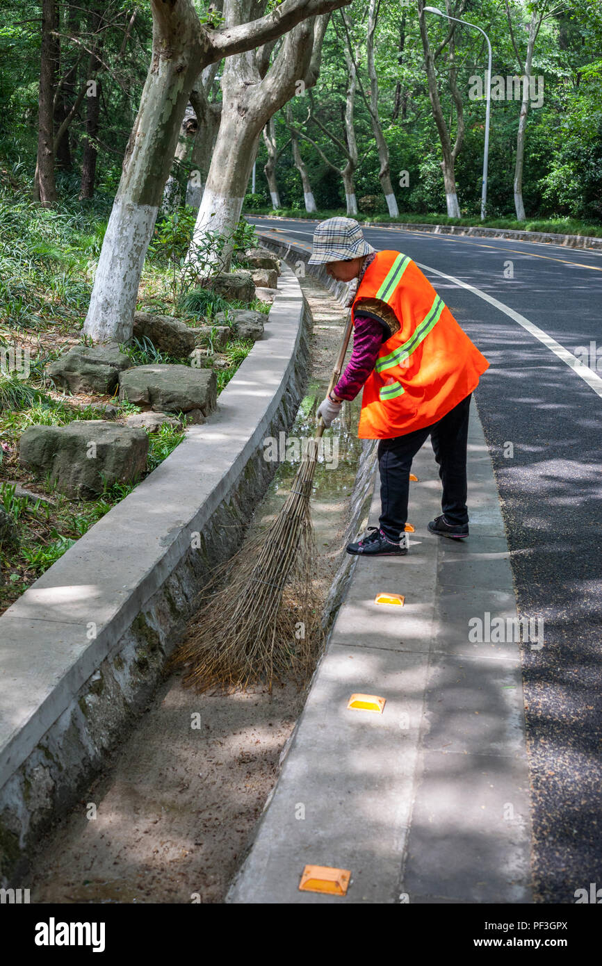 Nanjing, Jiangsu, China. Street Cleaner with Traditional Broom Stock ...