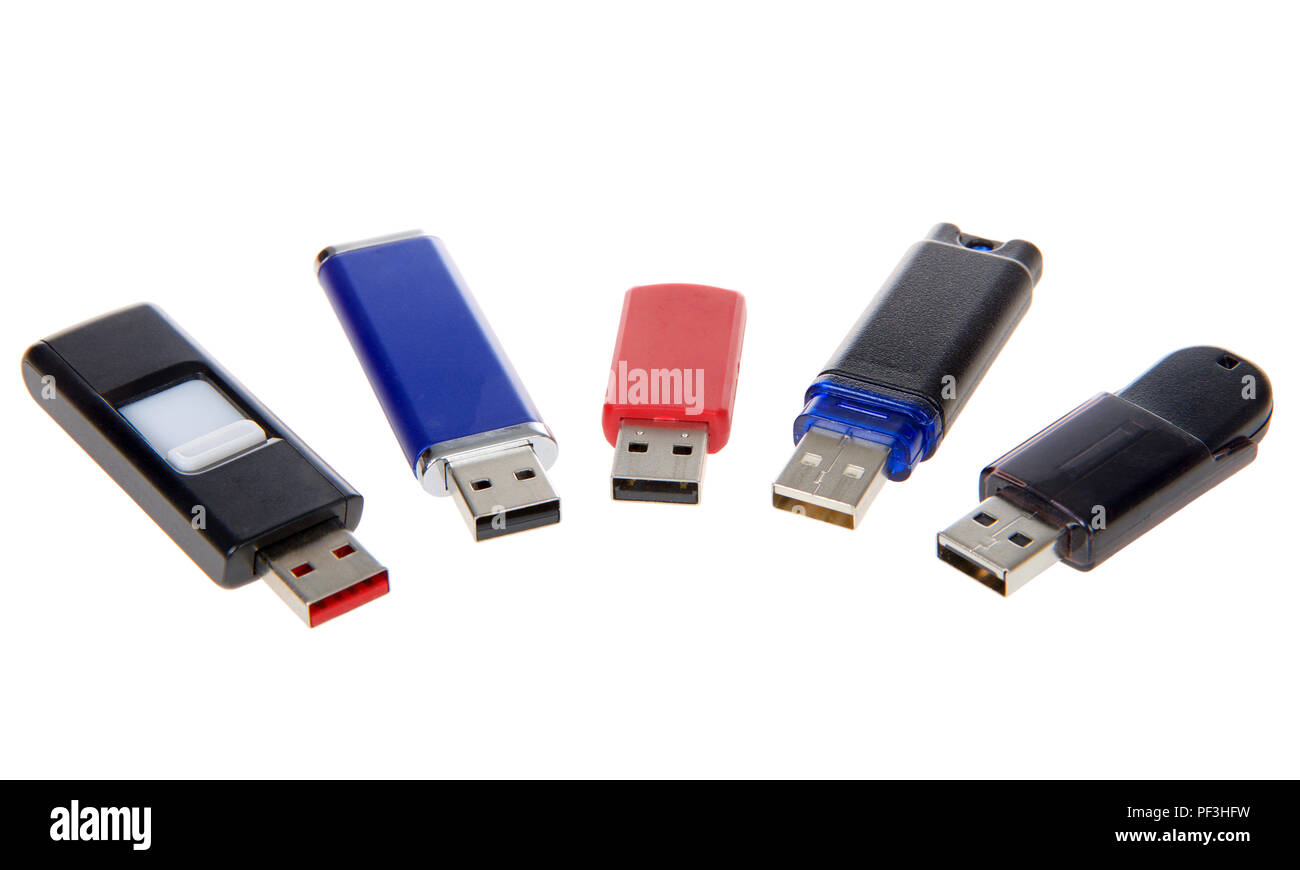 Multiple flash drives various colors and designs laying on white ...
