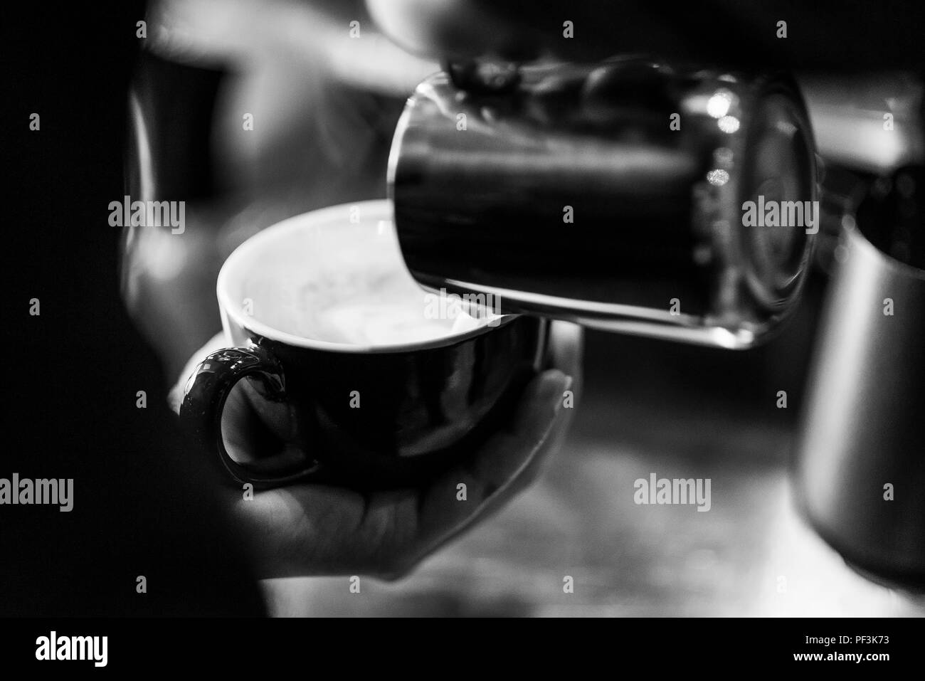 making espresso coffee BW black and white close up detail with modern ...