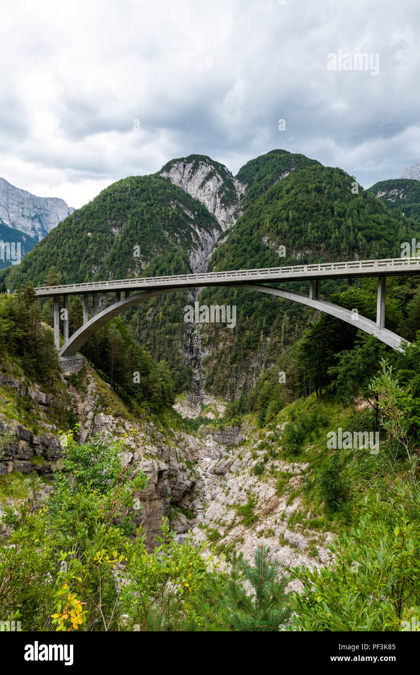 Mountain road with bridge spanning over a gorge in European Alps with ...