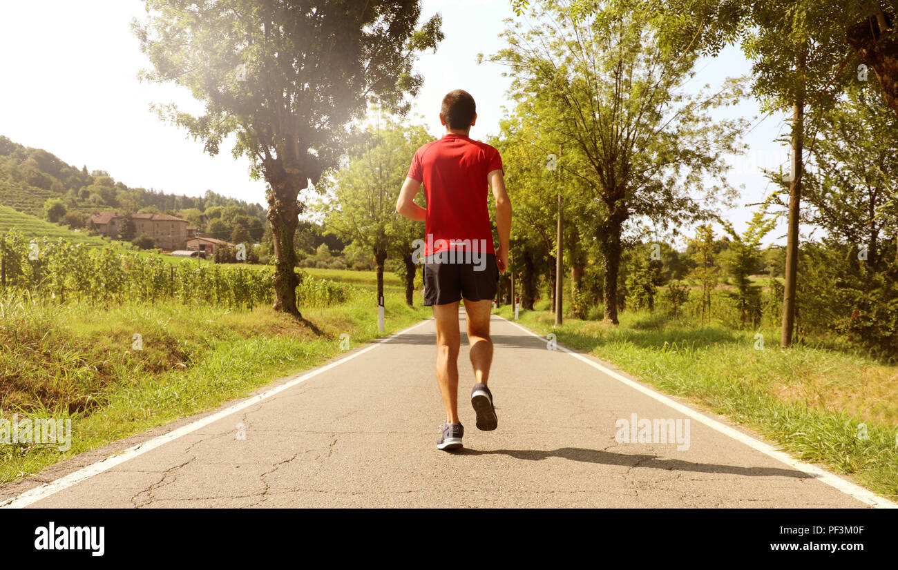 Back view man running outdoor Stock Photo - Alamy
