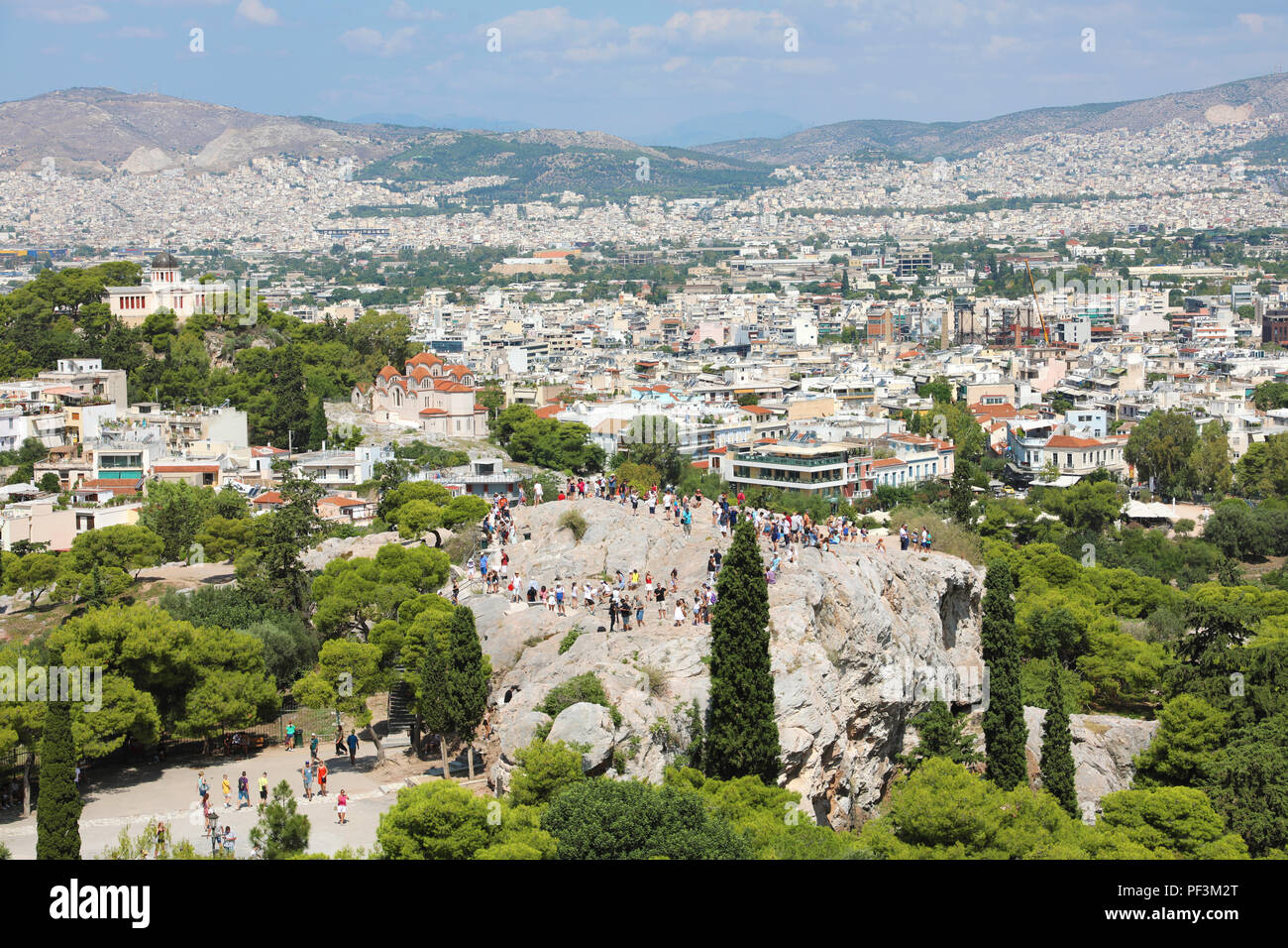 Areopagus rock with tourists and Athens Cityscape from the Acropolis ...