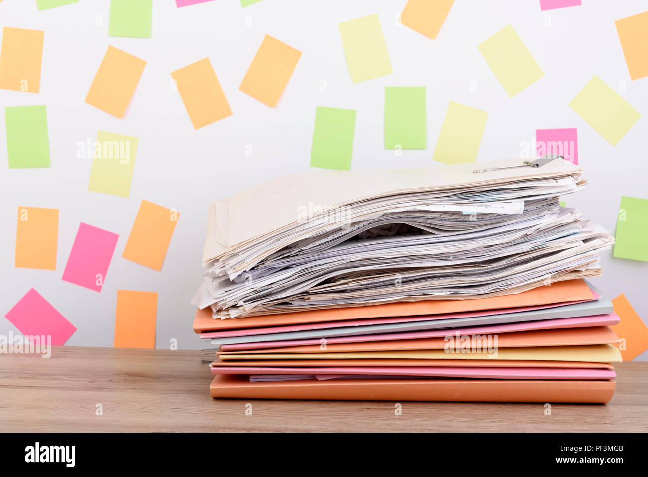Important documents stacked high on the office desk,Adhesive note on ...