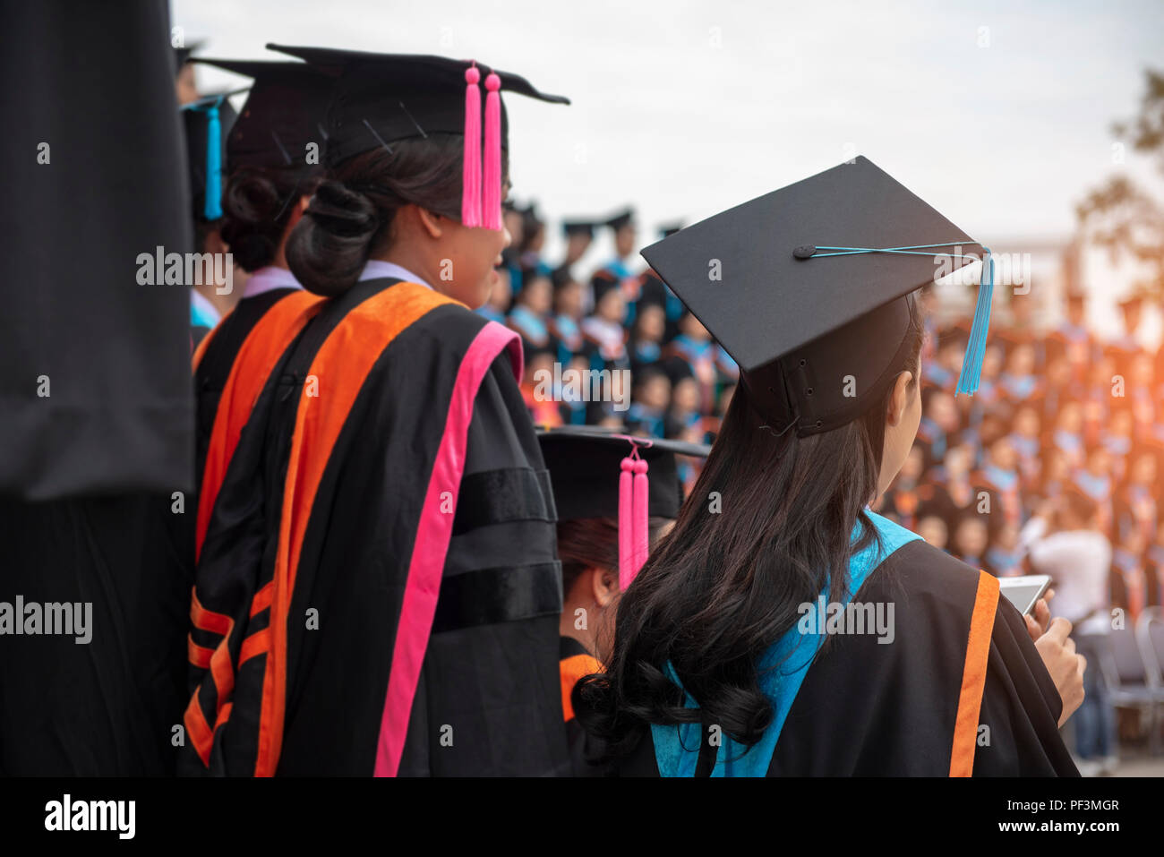 Back of graduation with black blue tail cap at ceremony in graduation ...