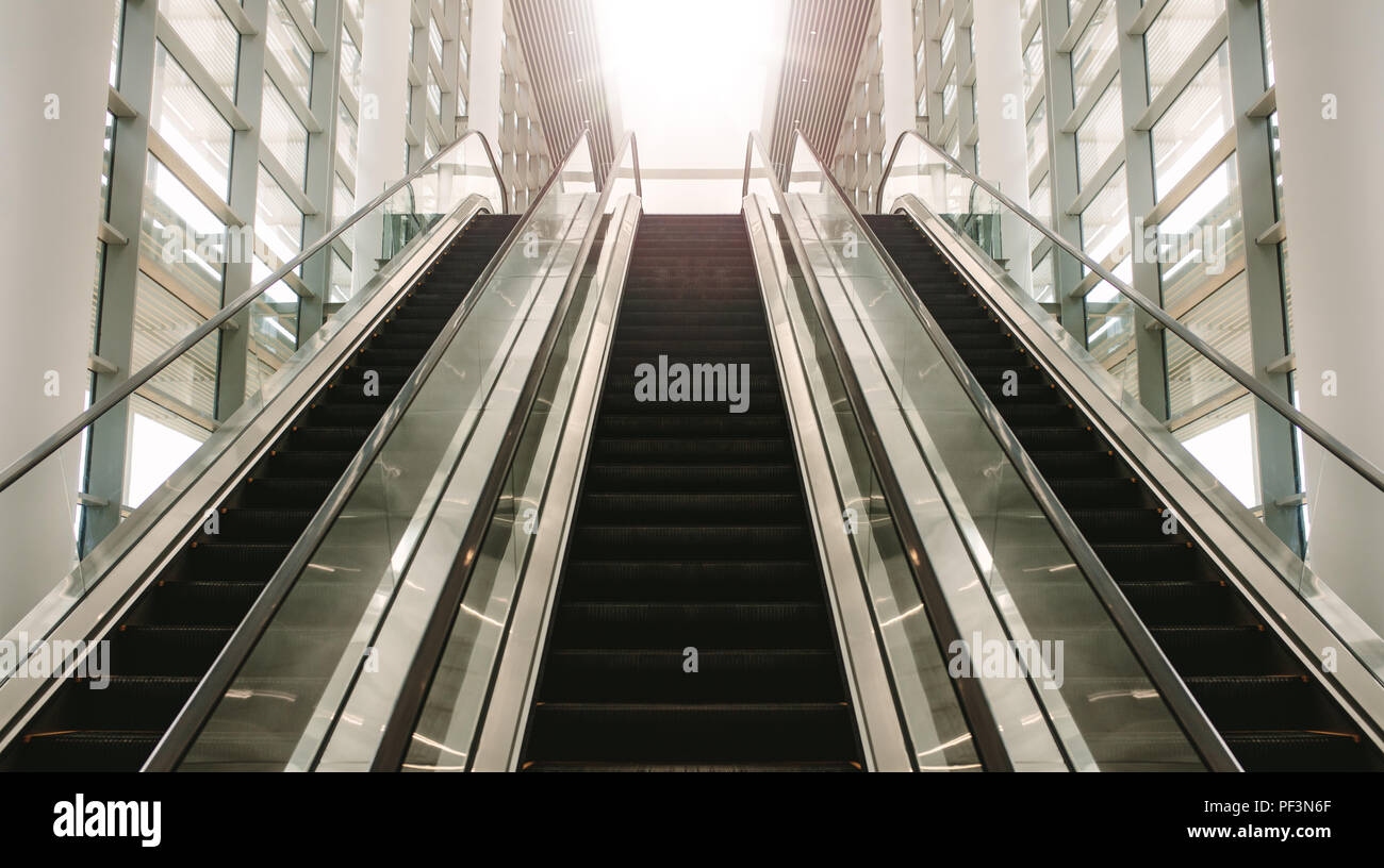 Escalator in a modern building. Empty bank of escalators leading out of ...