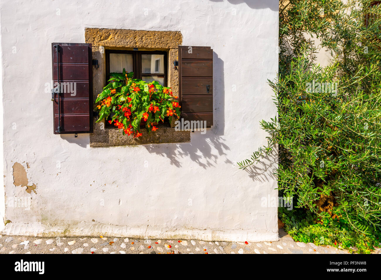 Window with shutters on the rustic stone wall, Mediterranean house with ...