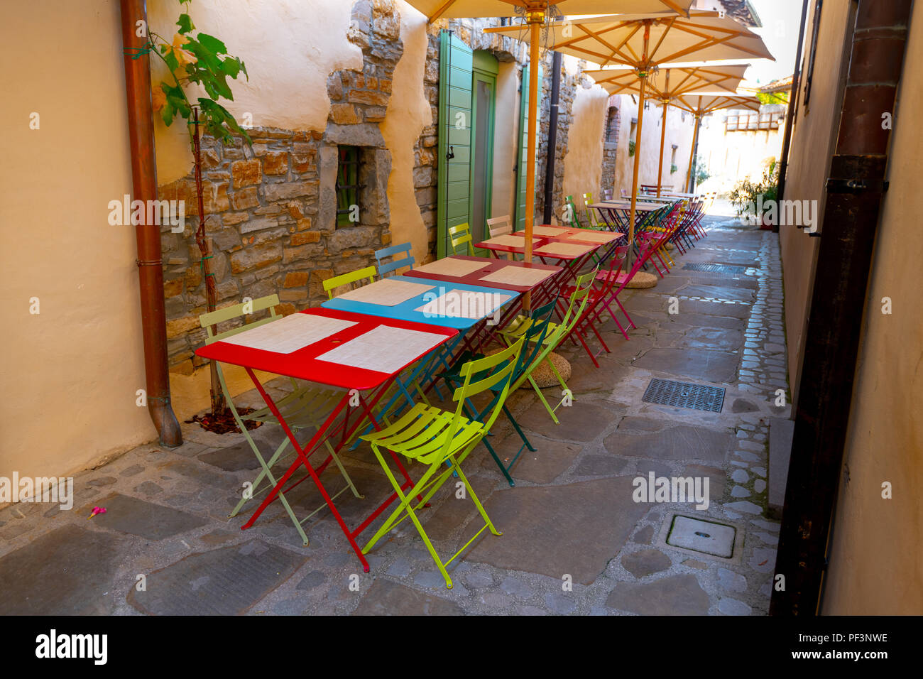 Small caffee, restaurant in narrow street in a medieval town with ...