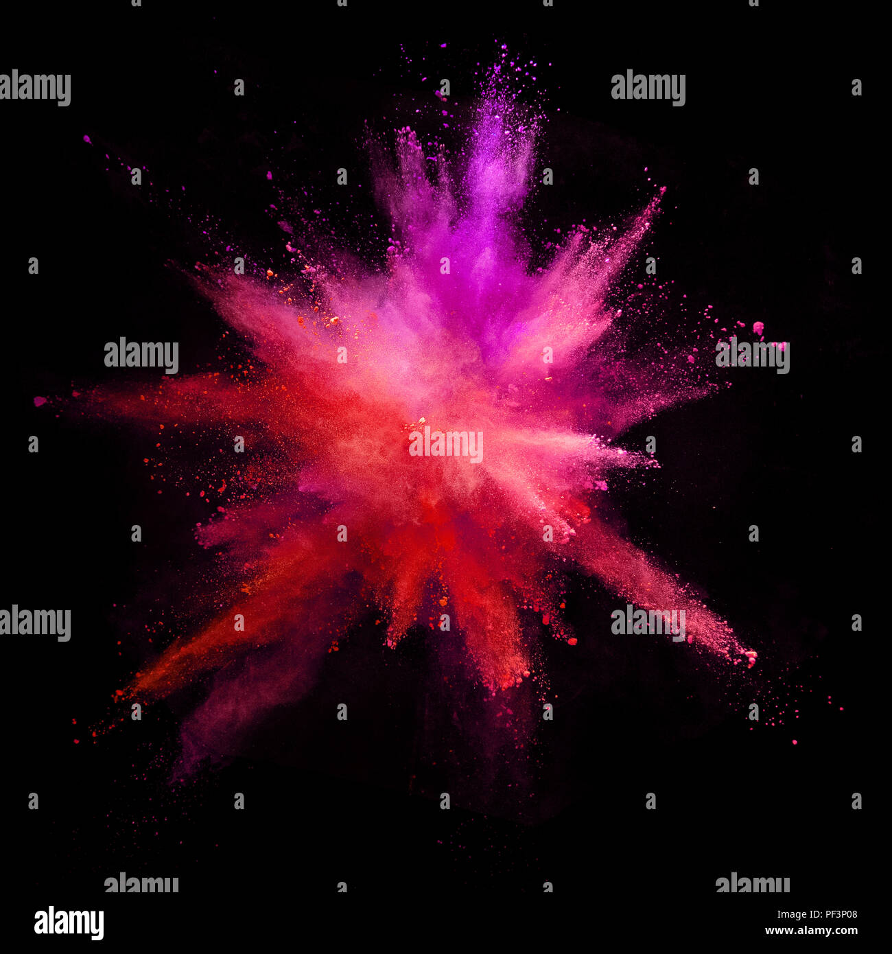 Explosion of coloured powder isolated on black background. Abstract ...