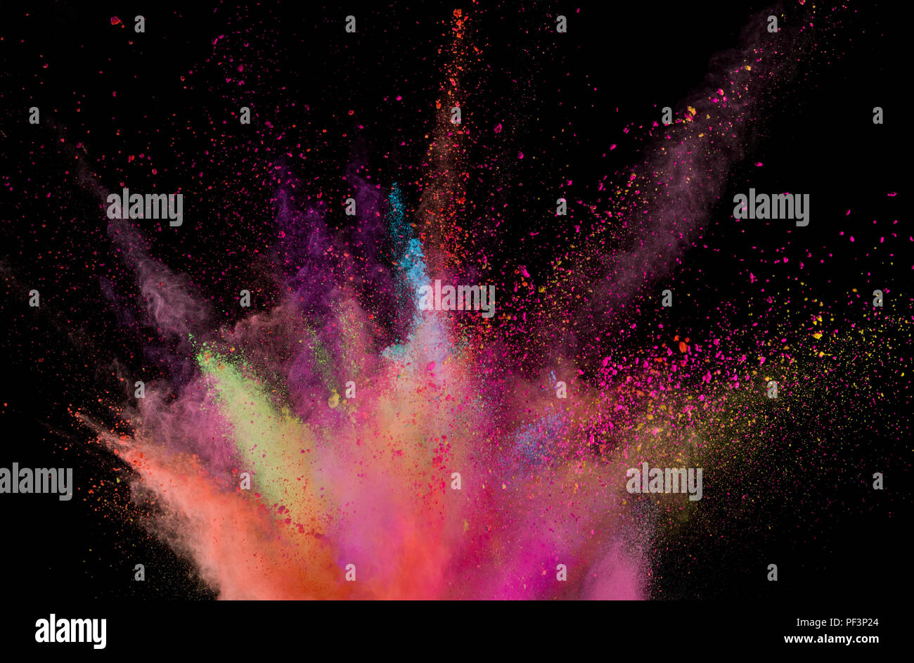 Explosion of coloured powder isolated on black background. Abstract ...