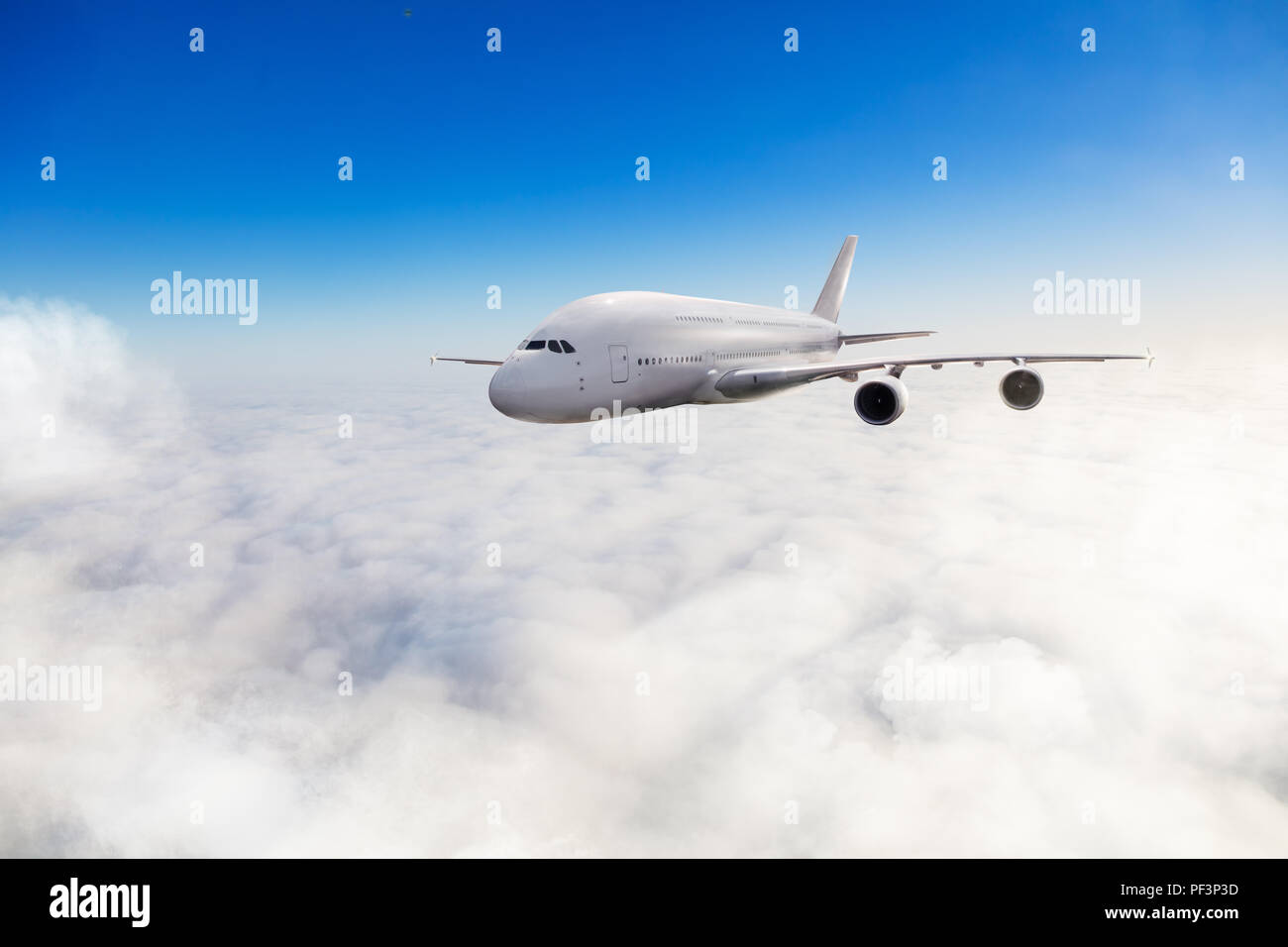 Huge two-storey passengers commercial airplane flying above clouds in ...
