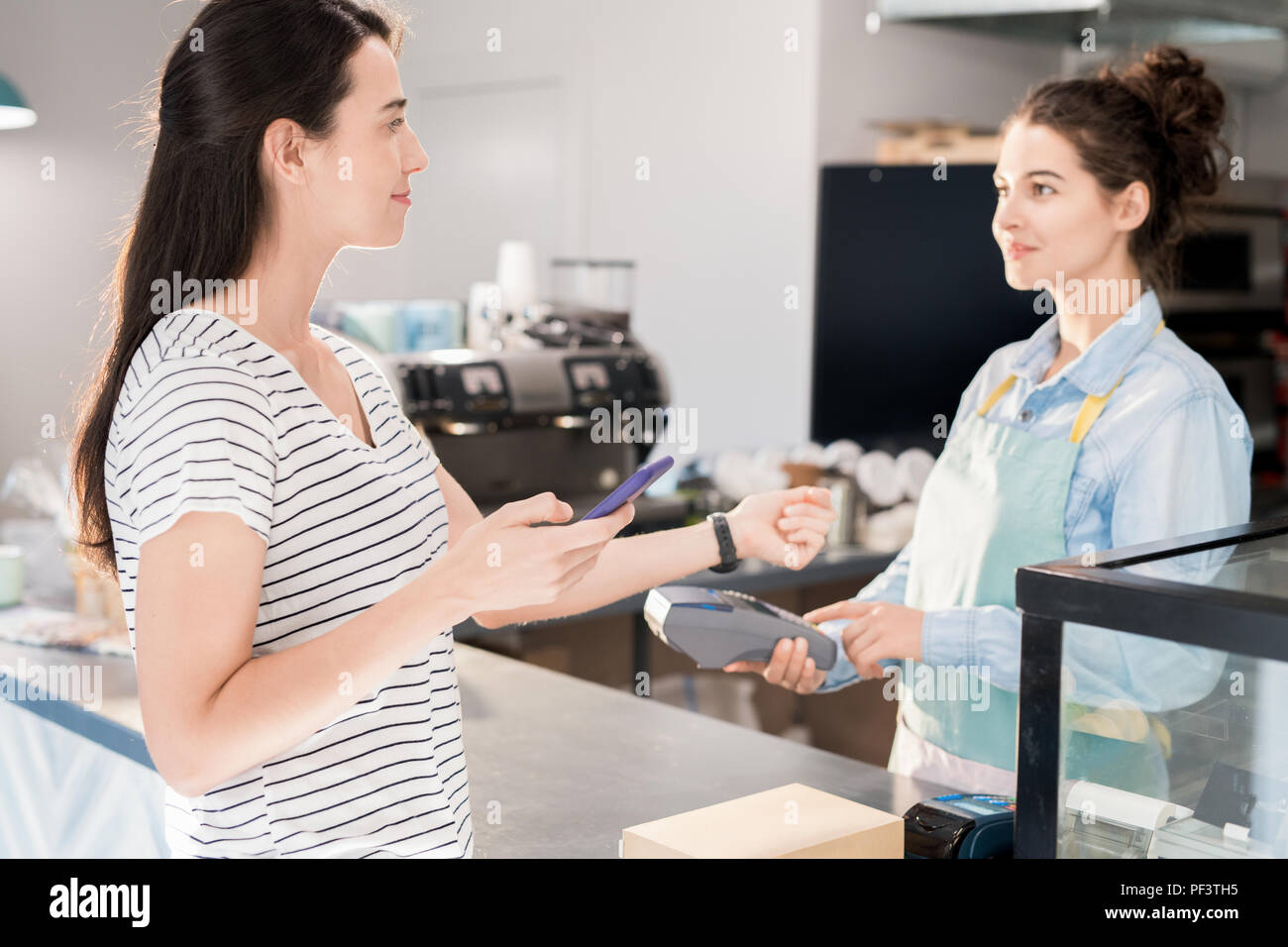 Modern Woman Paying by Smart Watch Stock Photo - Alamy