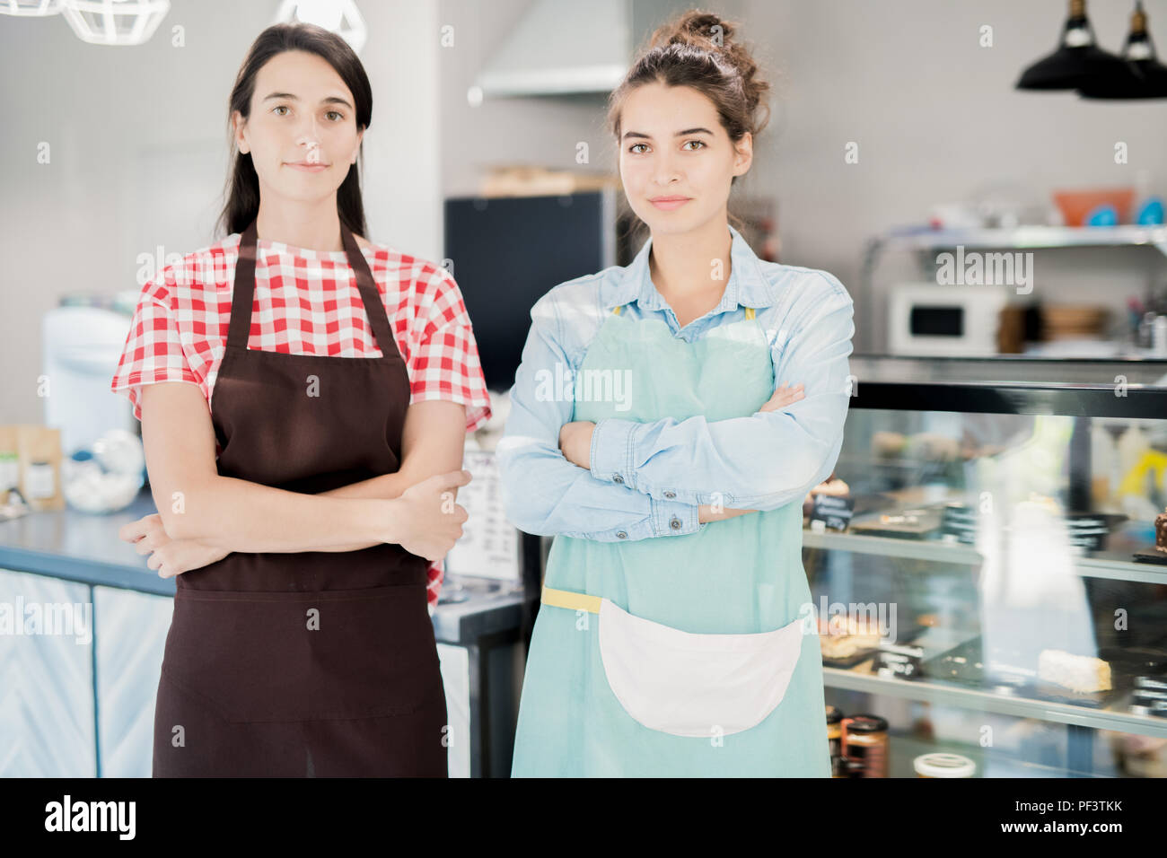 Two Waitresses Posing in Cafe Stock Photo - Alamy