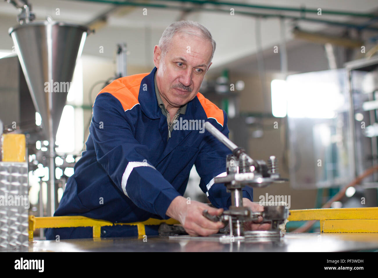 The worker at the factory does the work Stock Photo - Alamy