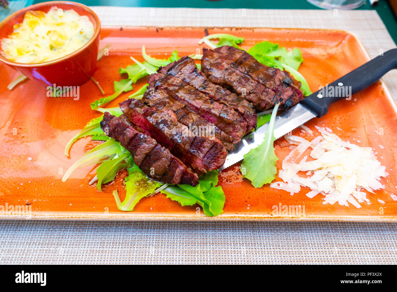 Traditional Italian Tagliata Steak with Parmesan and Salad as close-up ...