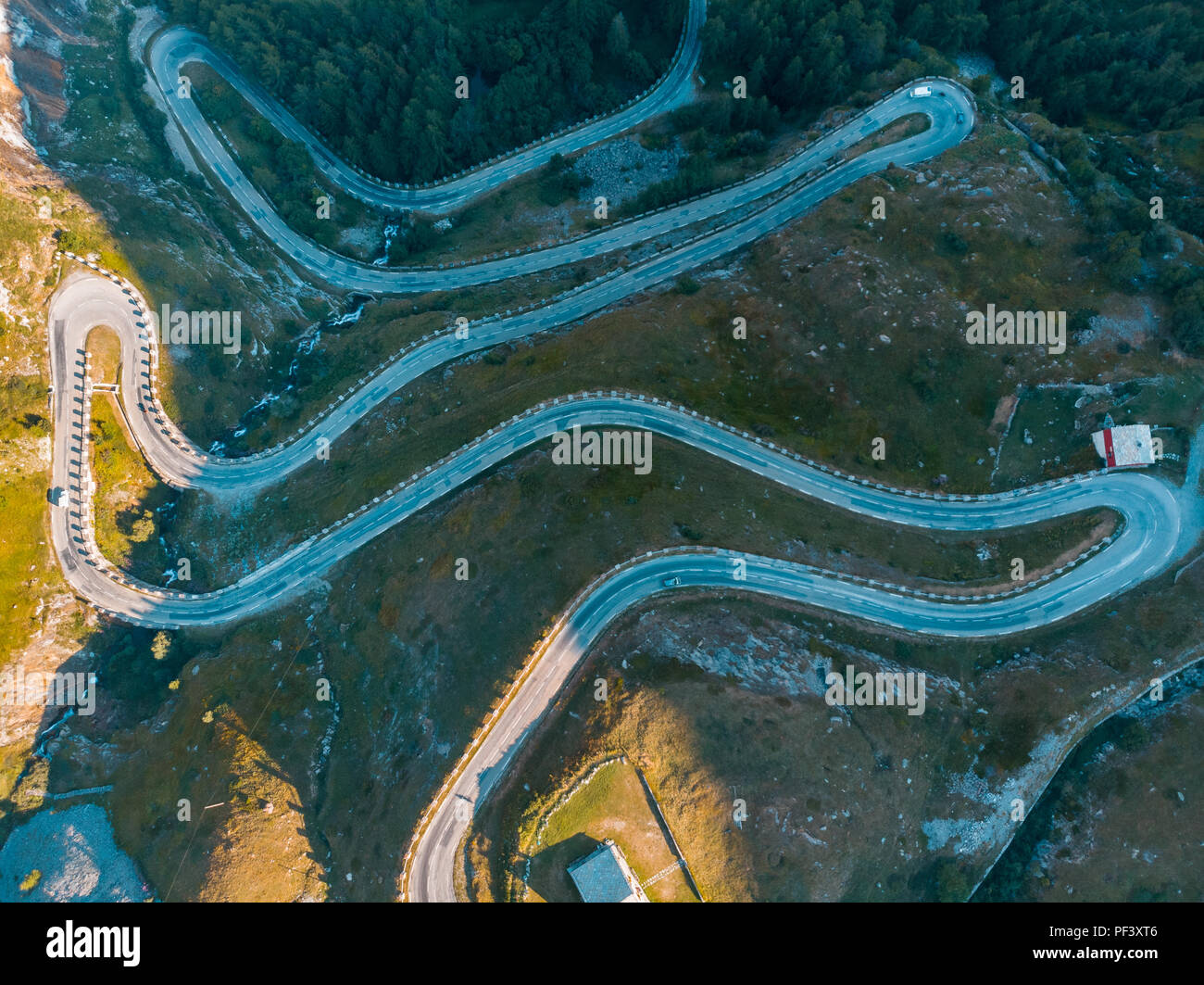 Aerial: top down view tailspin over winding mountain road on the ...