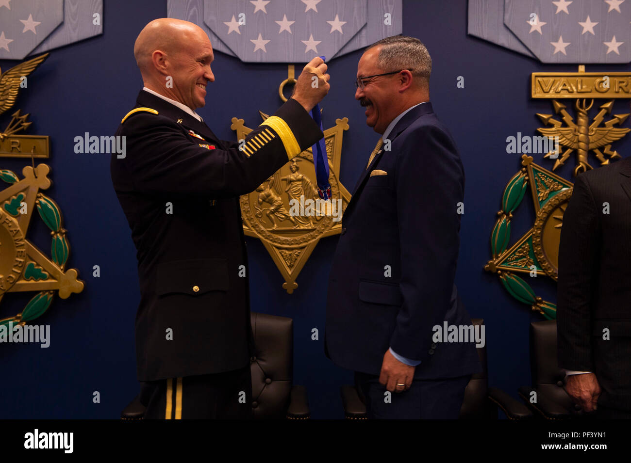 Michael A. Dunne, right, is presented with the Medal of Valor by Army ...
