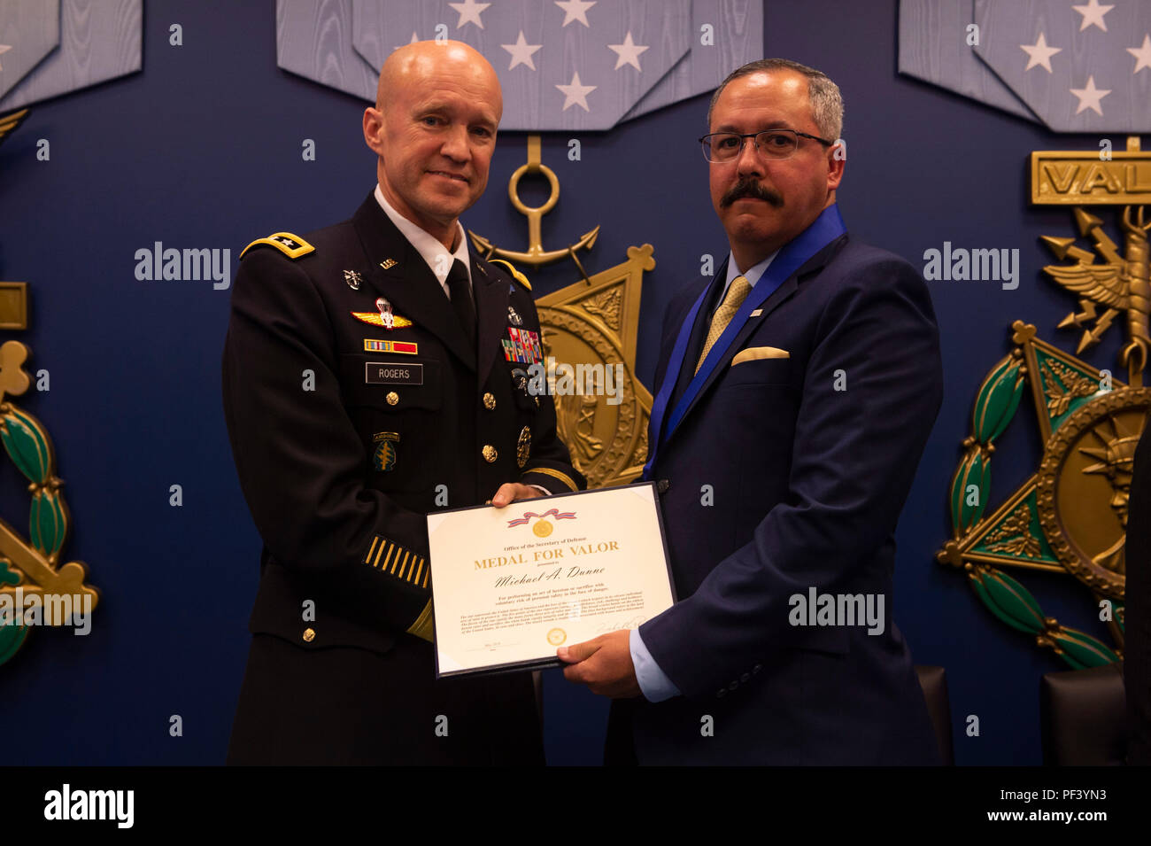 Michael A. Dunne, right, is presented with the Medal of Valor by Army ...