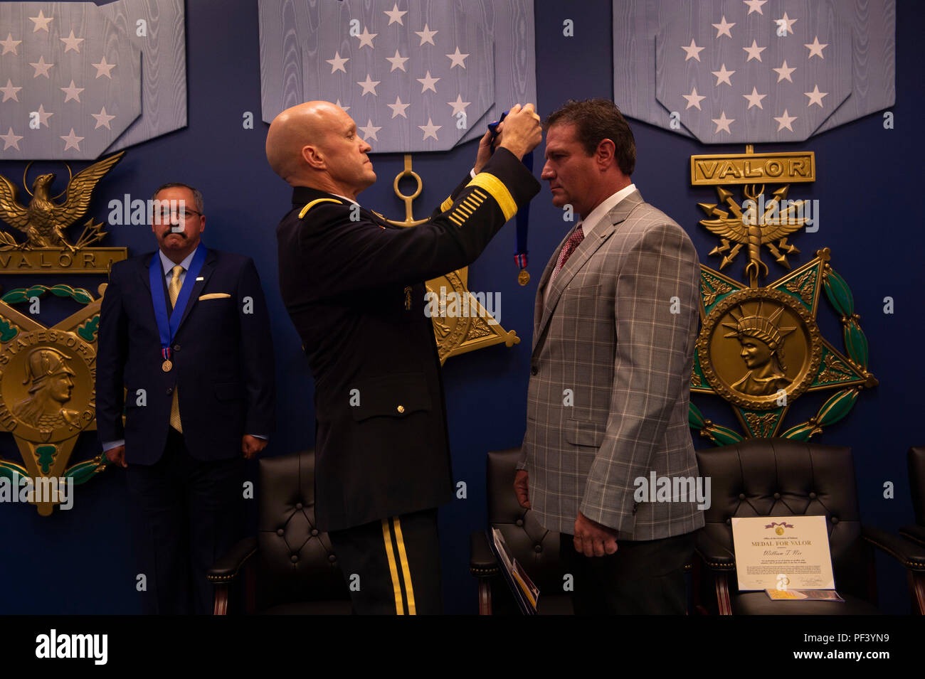 Brandon R. Seabolt, right, is presented with the Medal of Valor by Army ...