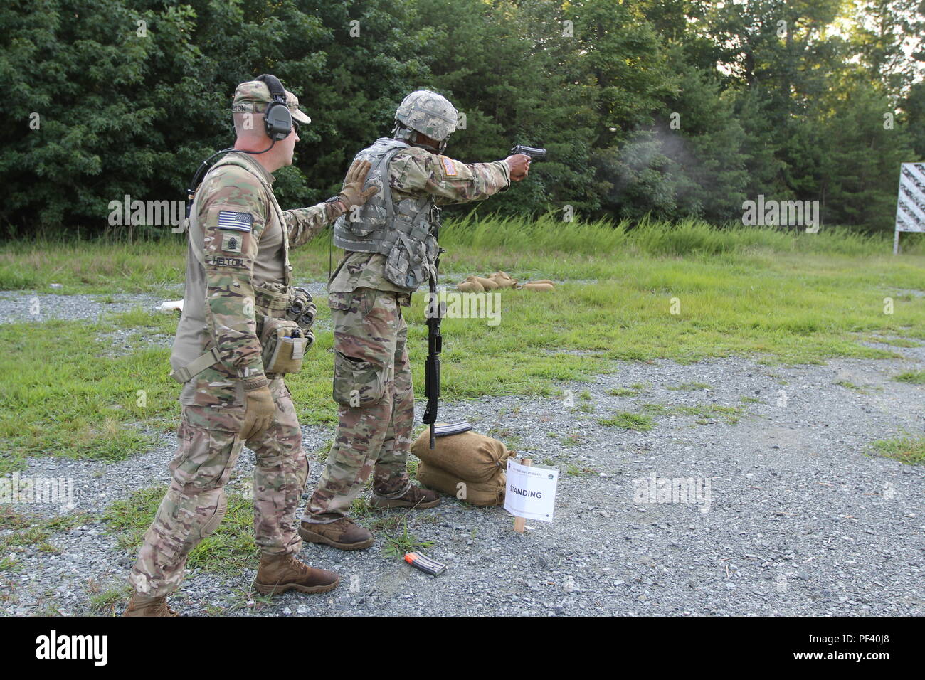 Sgt. 1st Class Deon Myers of the 21st Signal Brigade (right) fires his ...