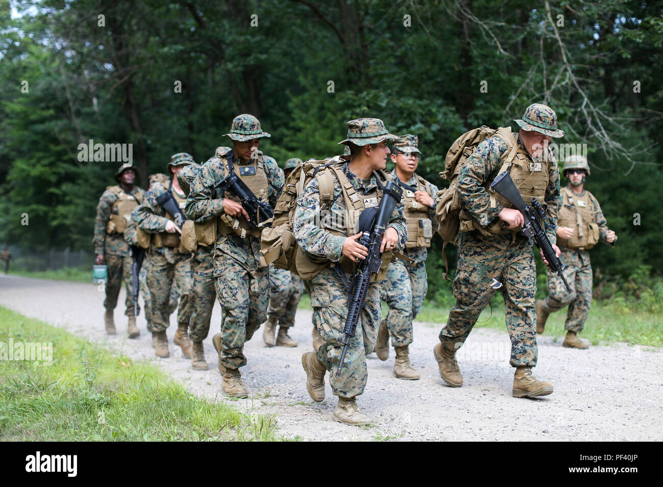 Marines with Marine Aviation Logistics Squadron (MALS) 13 carry gear as ...
