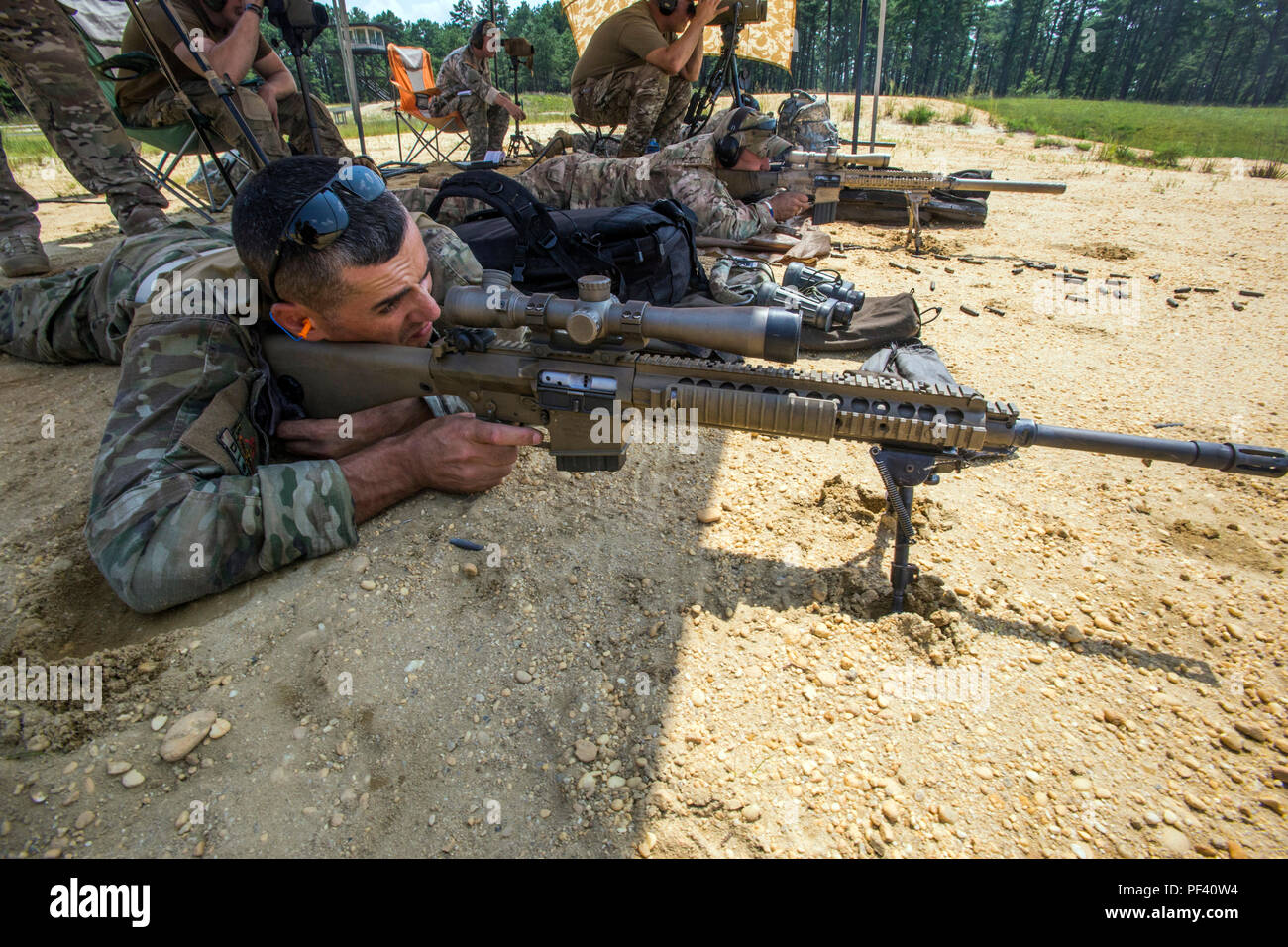 Albanian special forces sniper Staff Sgt. Ajet Disha, front, prepares ...