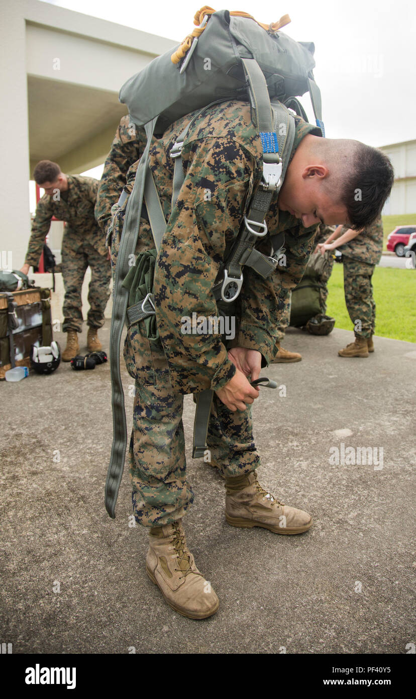 Lance Cpl. Connor Marrow straps on his MC-6 parachute in preparation ...