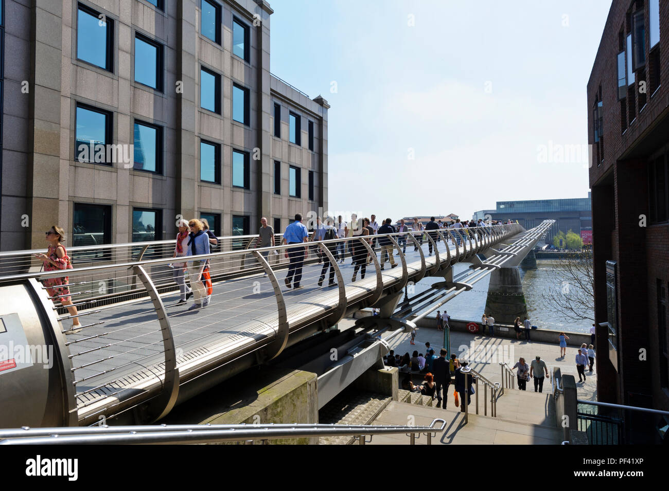 People crossing the Millenium bridge in London, England, UK Stock Photo ...