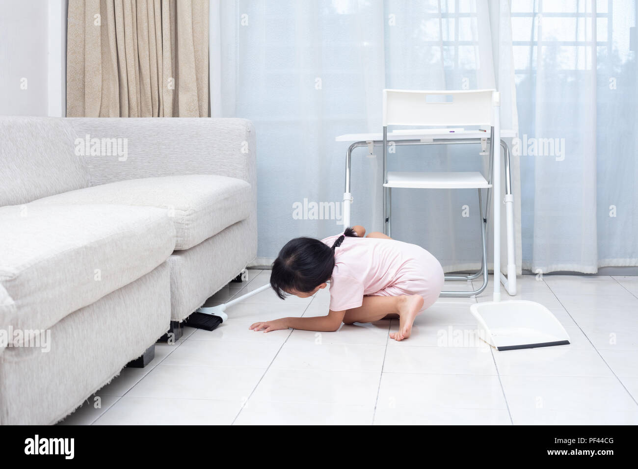 Asian Chinese little girl helping doing cleaning with broom and dustpan ...