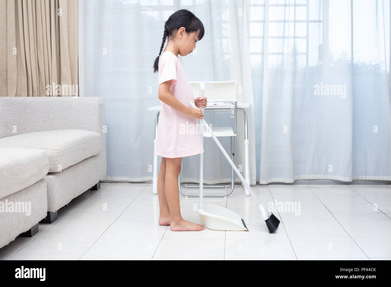 Asian Chinese little girl helping doing cleaning with broom and dustpan ...