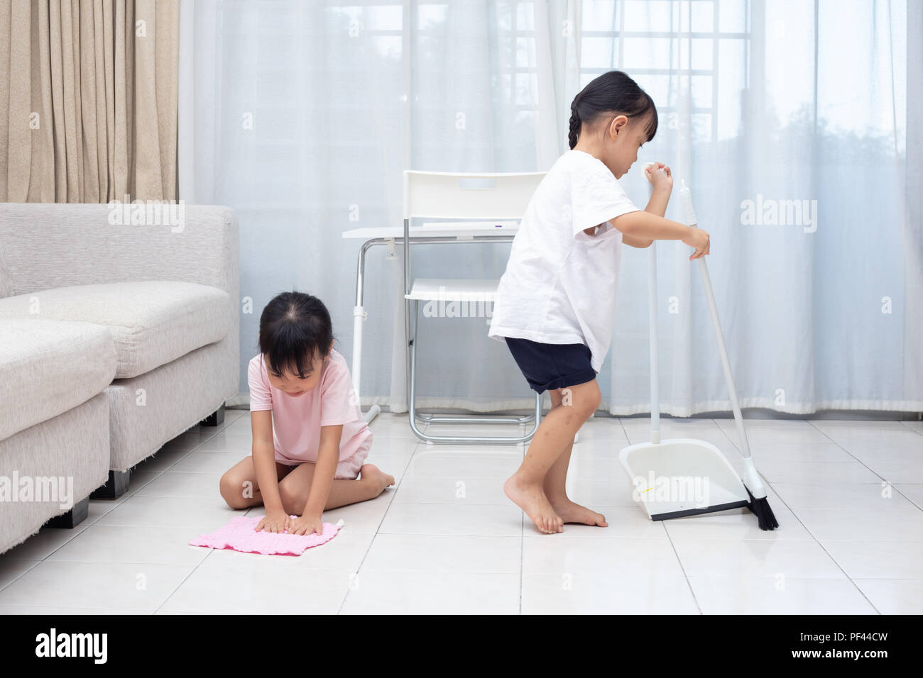 Asian Chinese little sisters helping doing cleaning at home Stock Photo ...