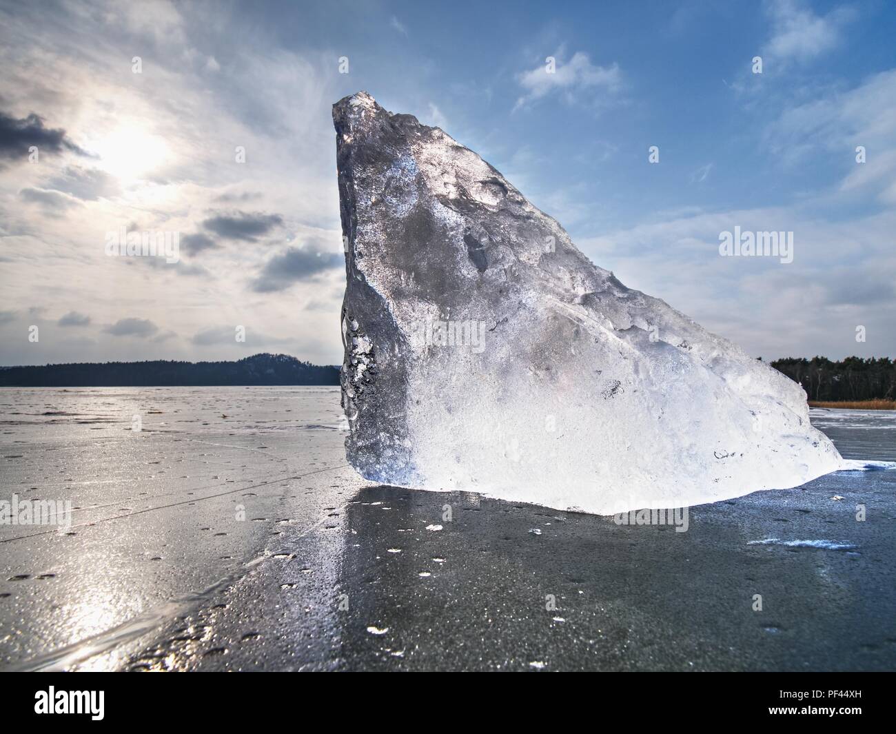 Ice breaking in pure nature. View over frozen water lake with sunset ...