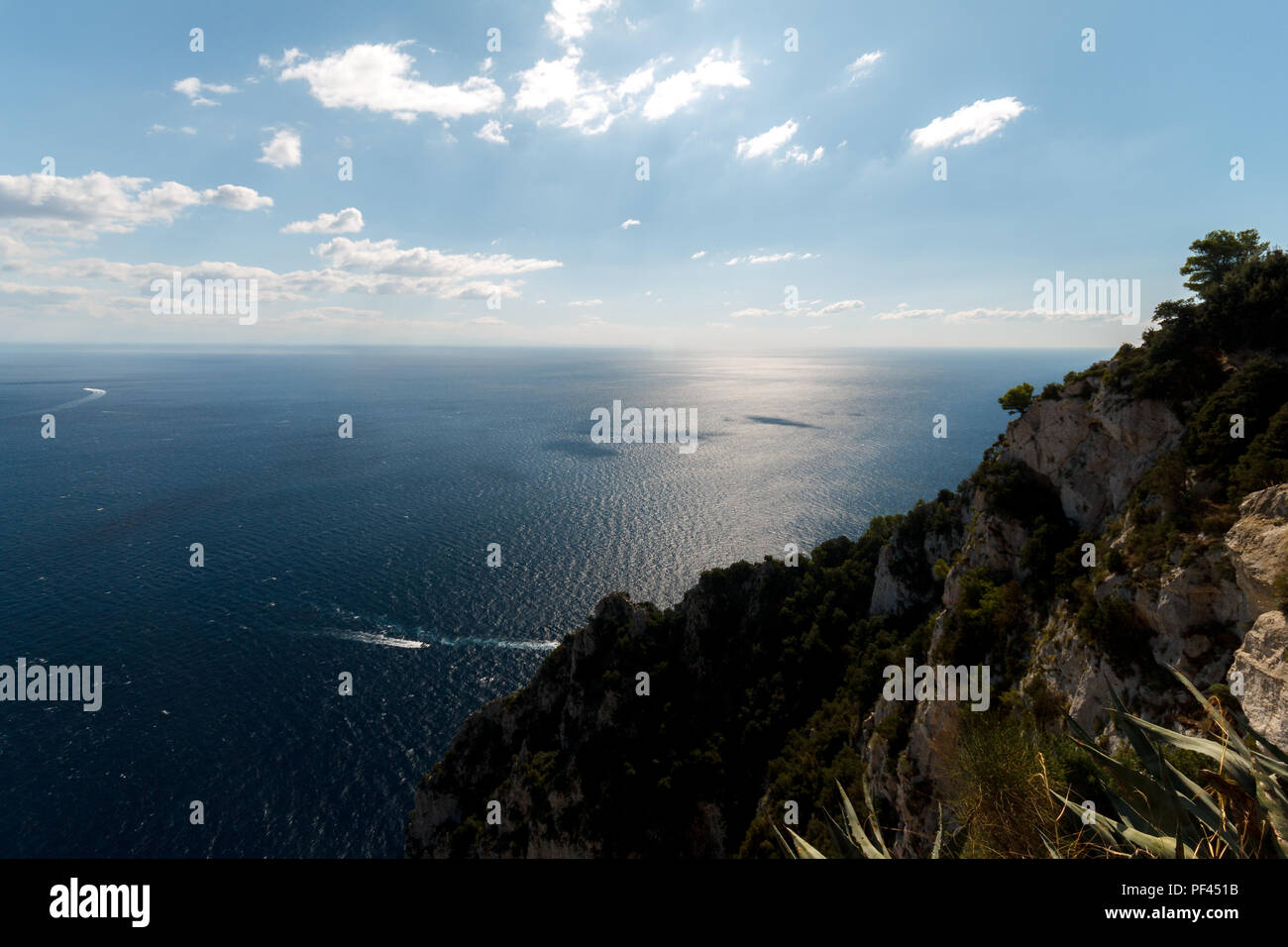 Beautiful aerial view of Capri island, with boat trails on the water ...