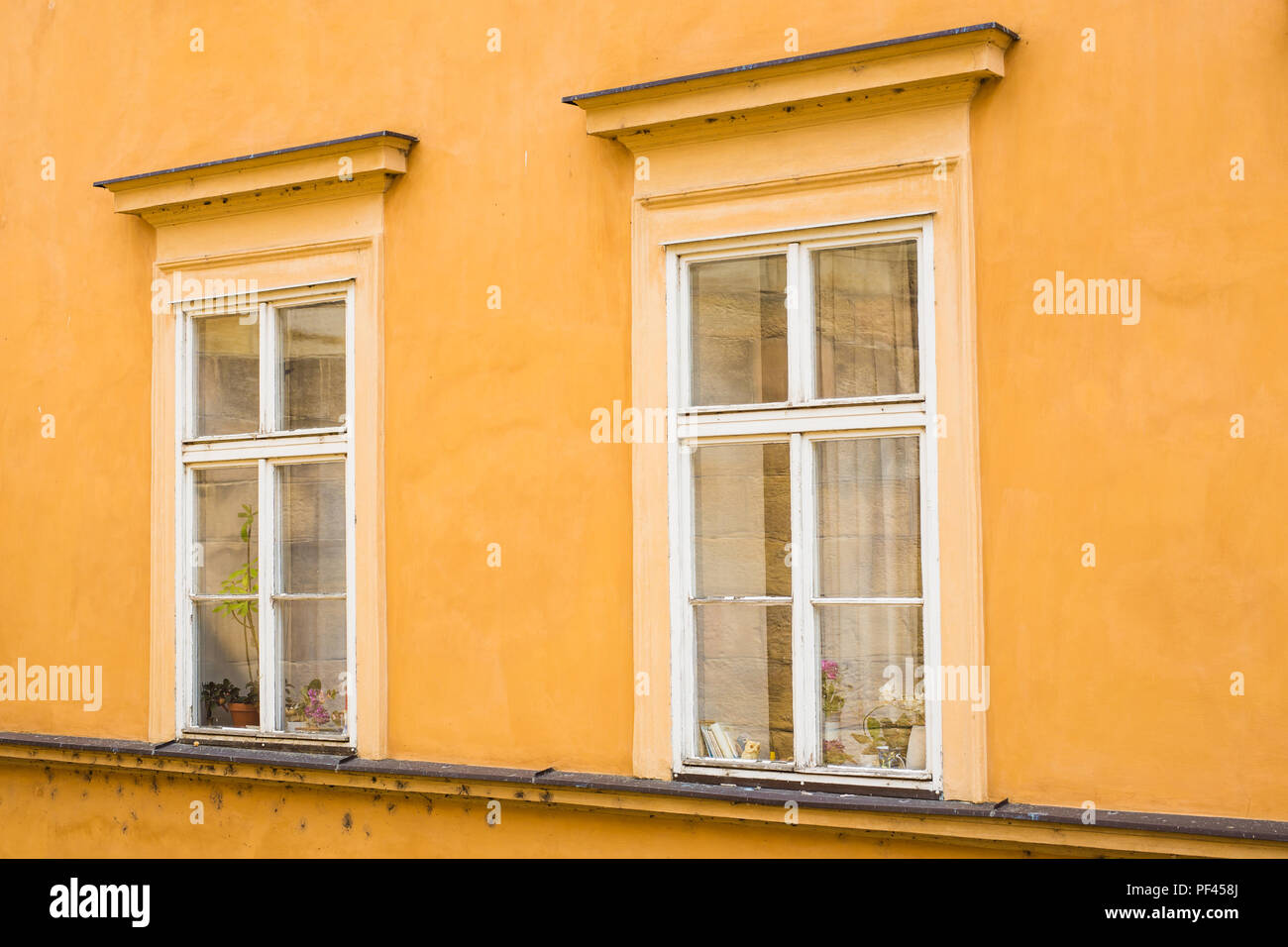 European yellow colorful house wall and windows Stock Photo - Alamy