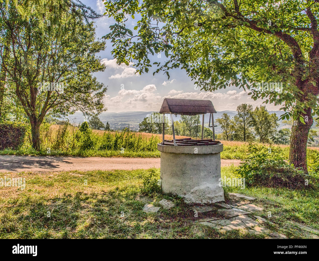 Old, stone, water well with a windlass and crank in the polish village ...