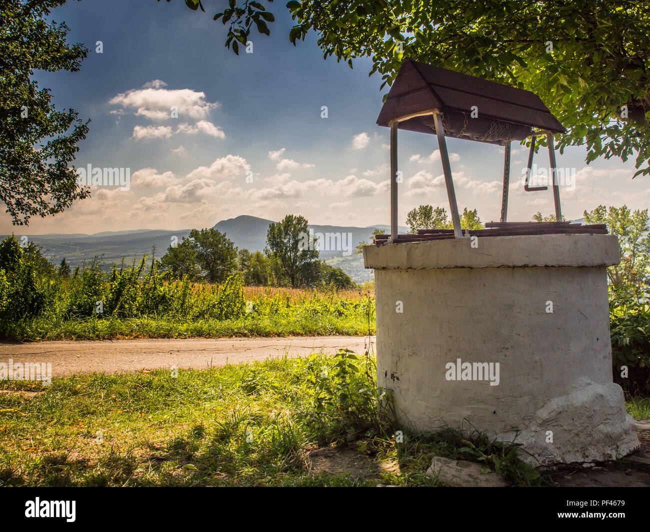 Old, stone, water well with a windlass and crank in the polish village ...