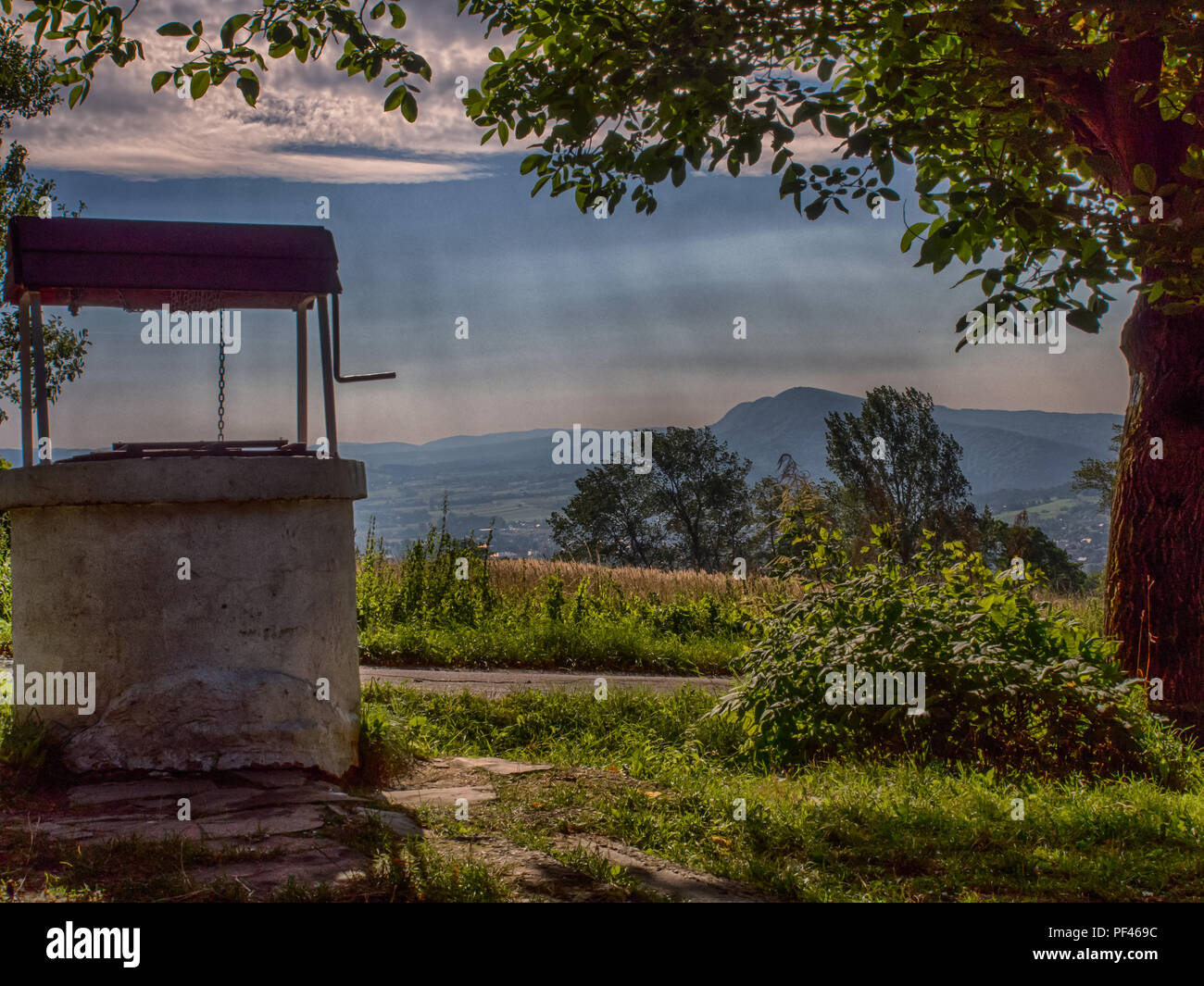 Old, stone, water well with a windlass and crank in the polish village ...