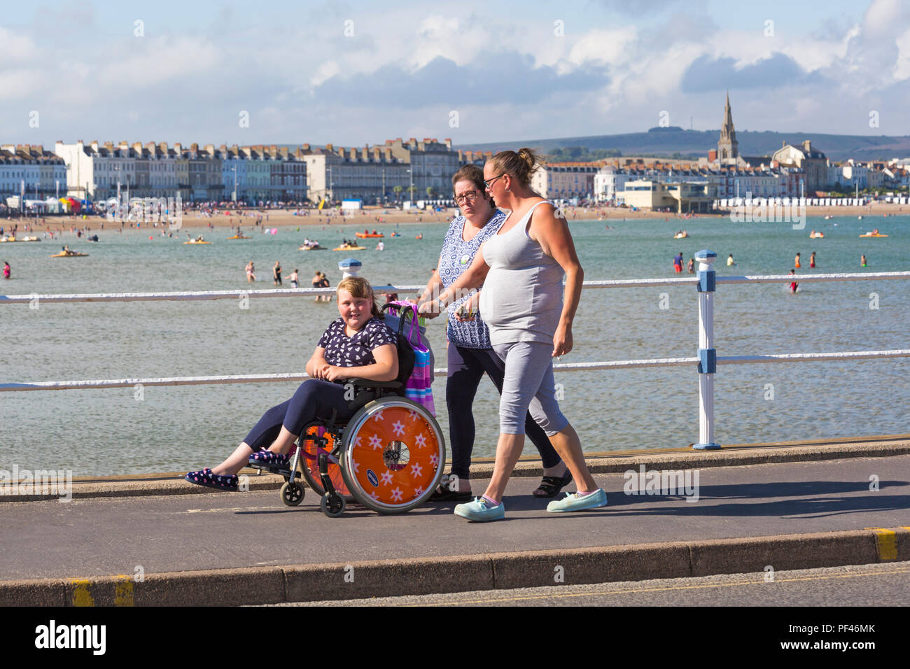 Girl pushing wheelchair hi-res stock photography and images - Alamy