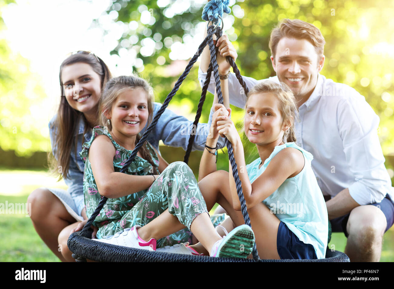 Picture showing joyful family having fun on playground Stock Photo - Alamy