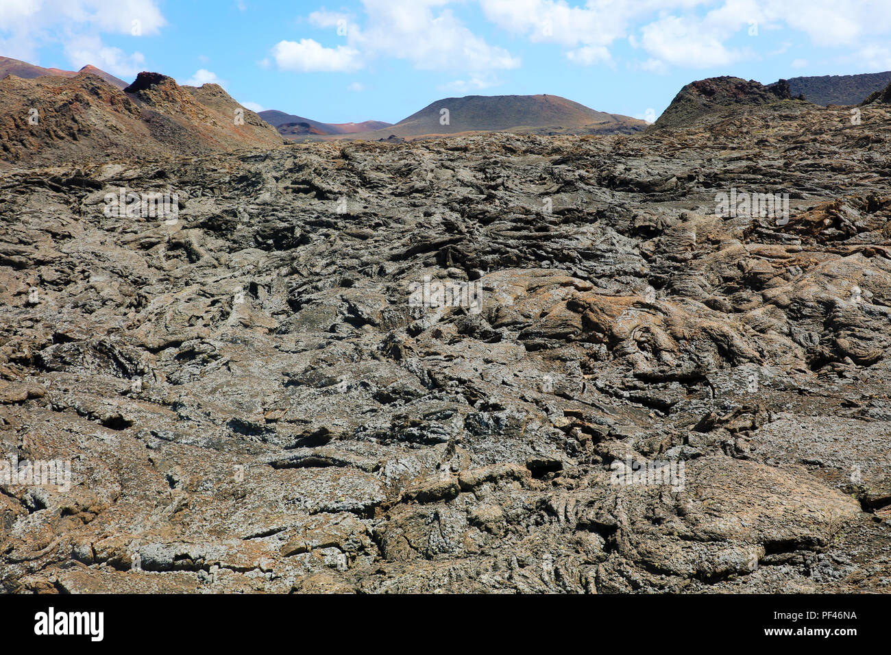 Solidified lava flow and crust with volcanic mountains on the ...