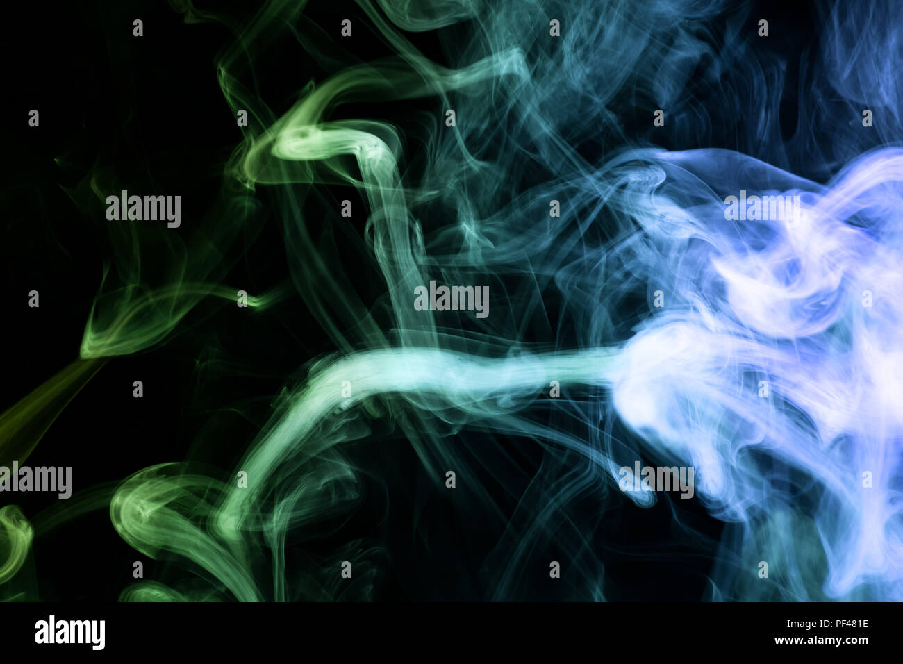 Thick blue and green smoke on a black isolated background. Background ...