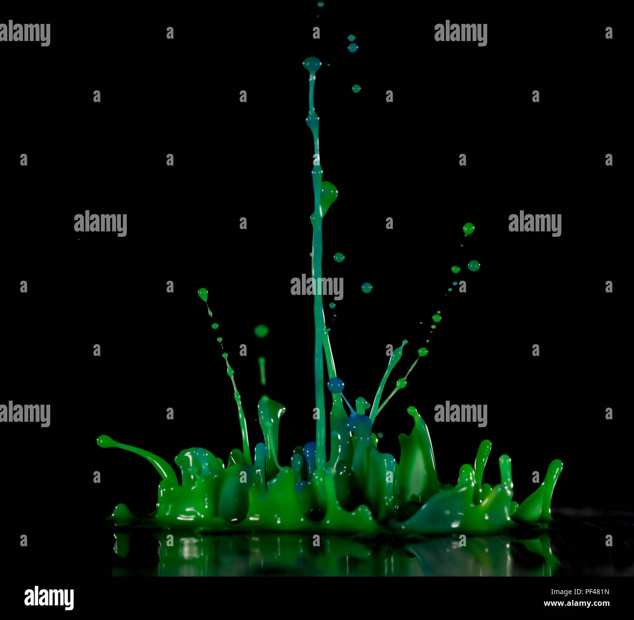 Green paint, ink splash on black background Stock Photo - Alamy