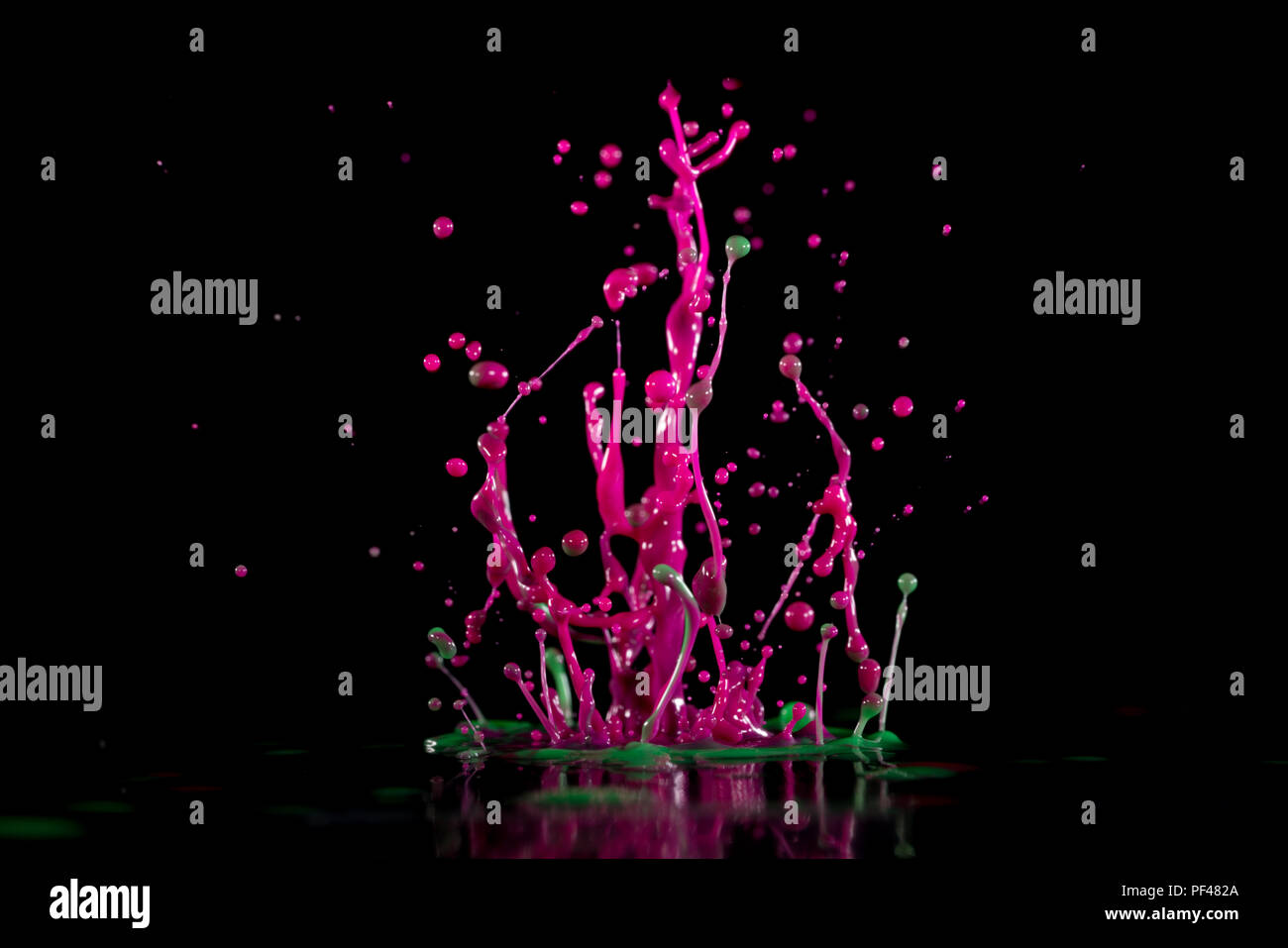 Magenta, pink paint, ink splash on black background Stock Photo - Alamy